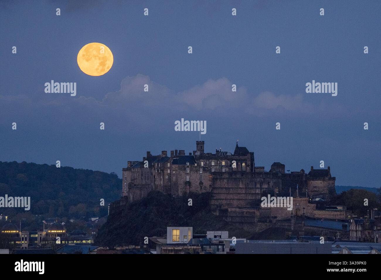 The full October moon, known as the Hunter's sets behind Edinburgh ...