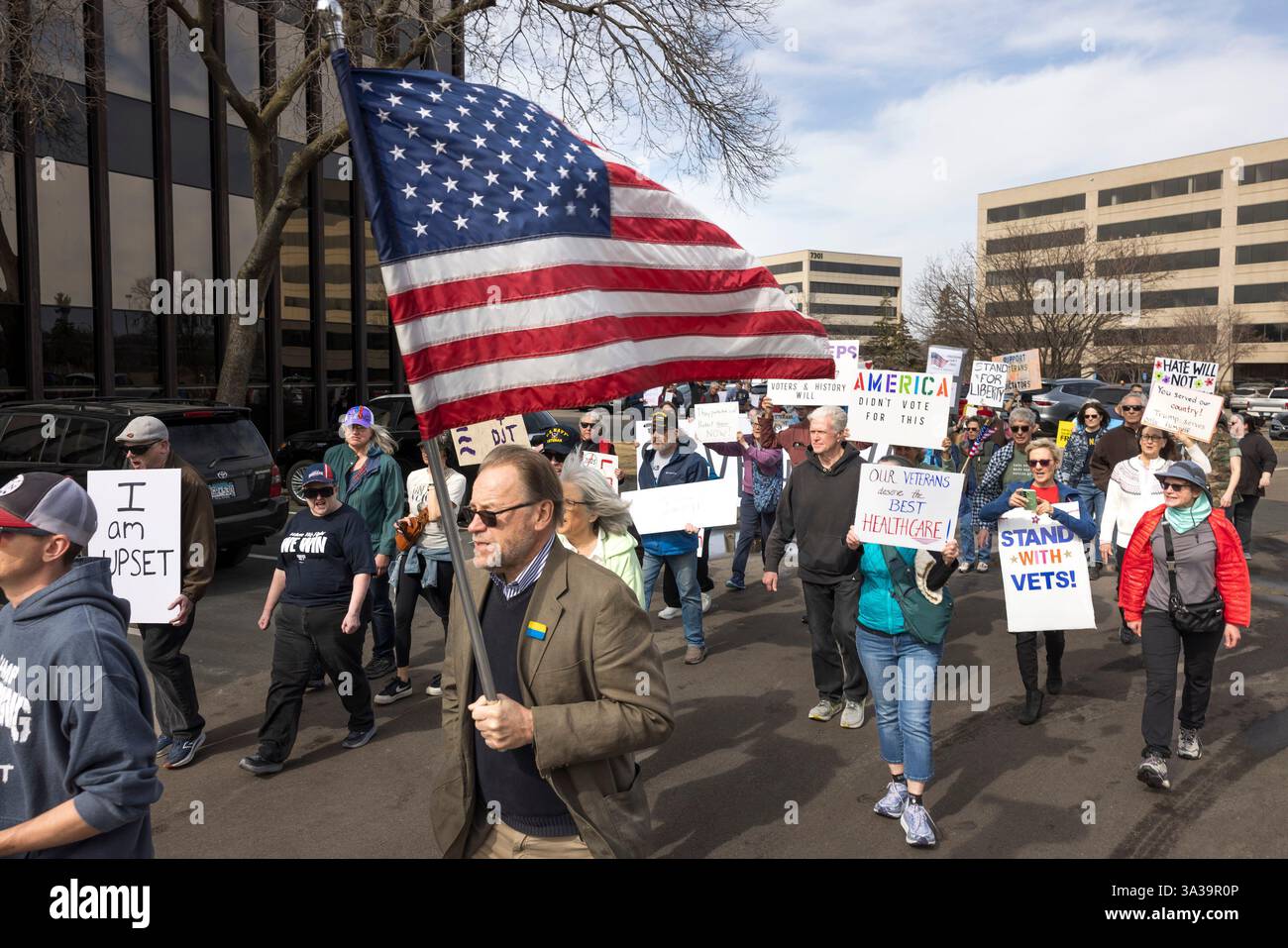 Veterans and their supporters gather outside the offices of the ...