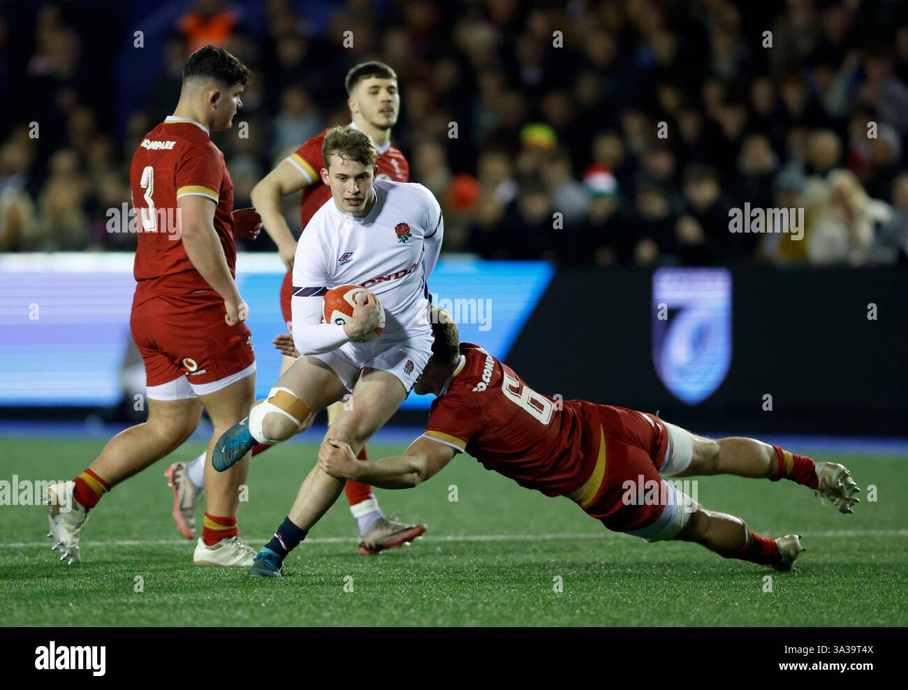 England's George Pearson (second left) is tackled by Wales' Deian ...