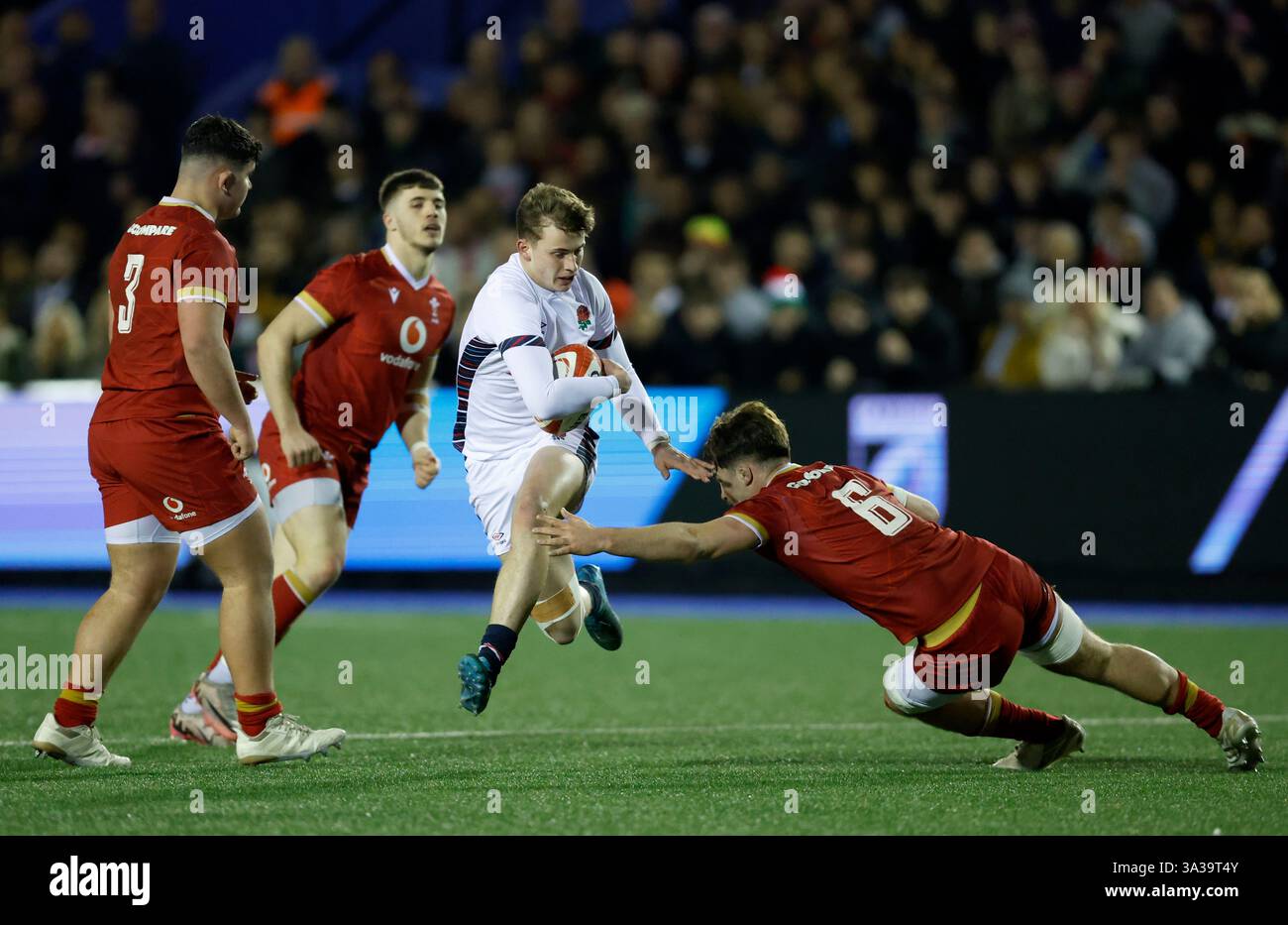 England's George Pearson (second left) is tackled by Wales' Deian ...