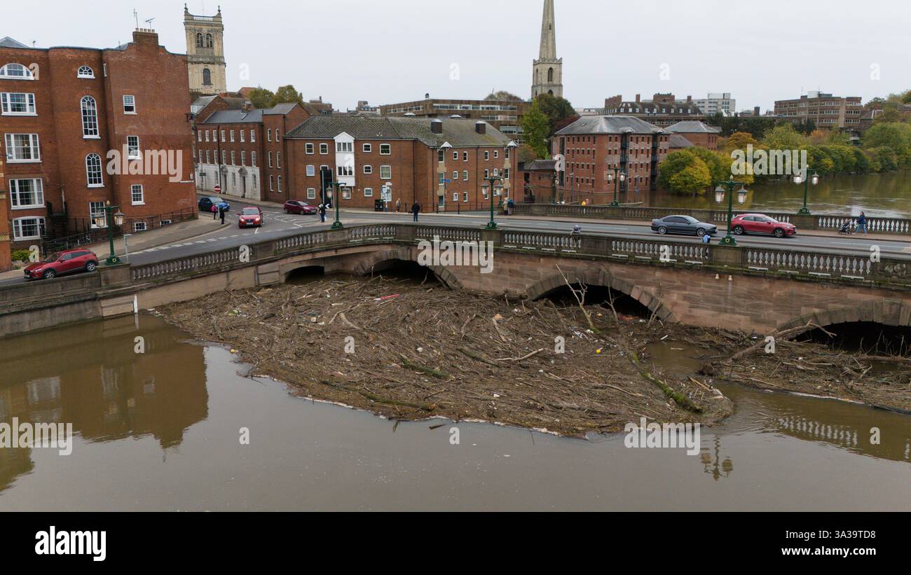 Debris by a bridge on the river Severn in Worcester. Flood warnings ...