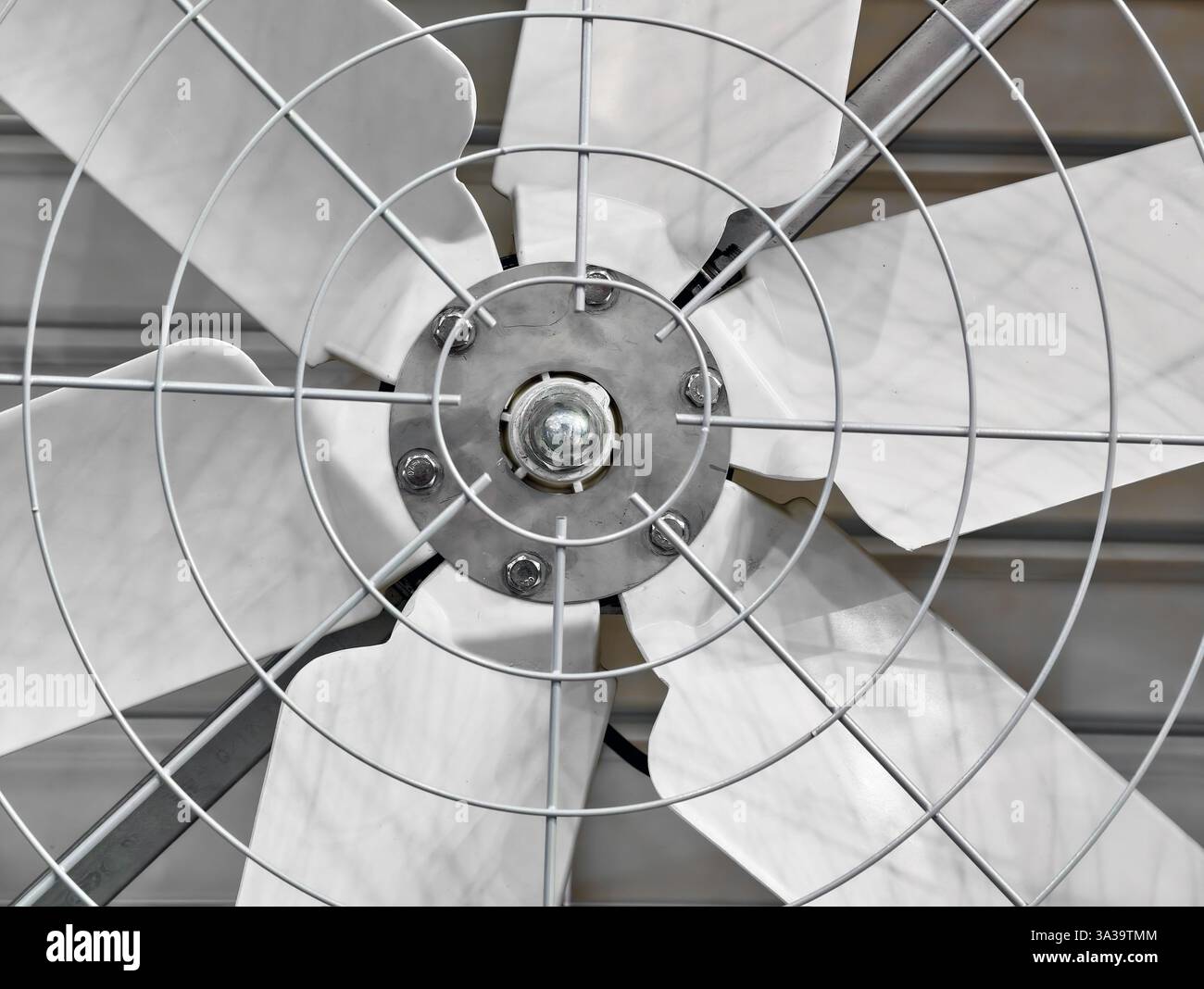 Industrial fan in an expansive warehouse illuminating the connection ...