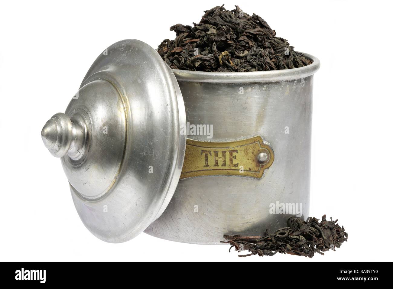 Ceylon Black Tea in a vintage French aluminum lidded tin isolated on ...