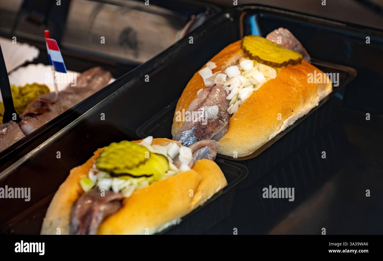 Famous barrel salted herring fish from the North Sea, fresh bun with ...