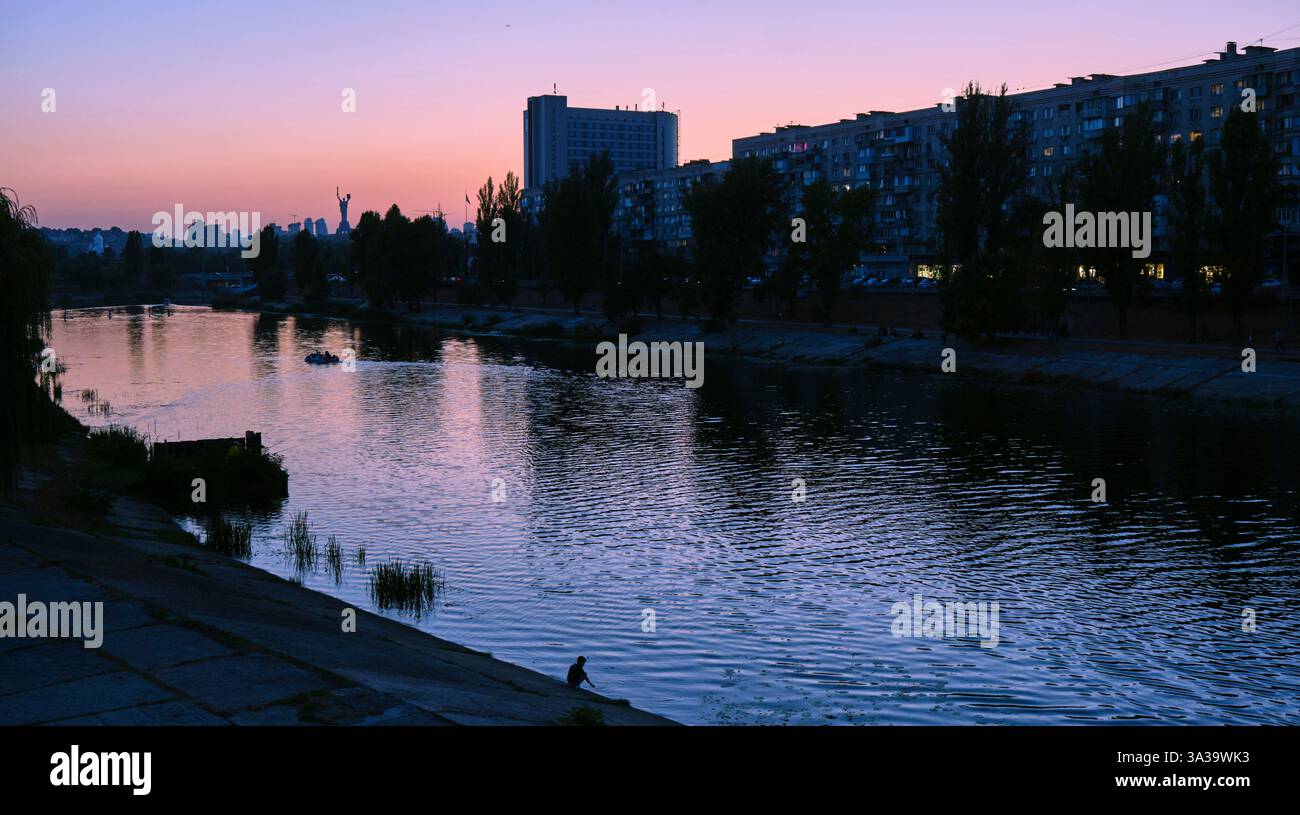 Colors of dusk illuminate the river, creating a peaceful atmosphere ...