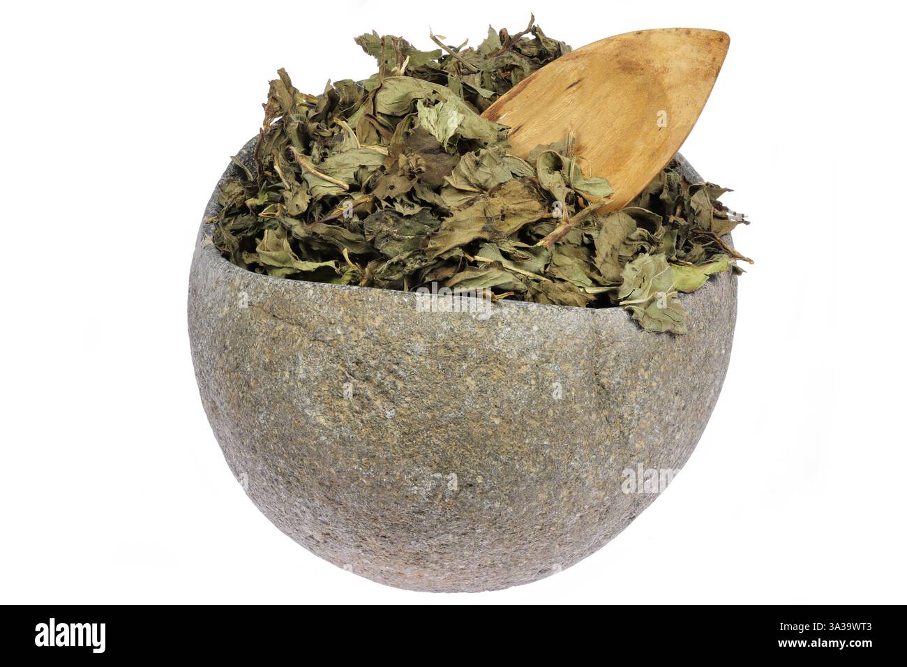 peppermint tea leaves in a natural river stone bowl isolated on white ...