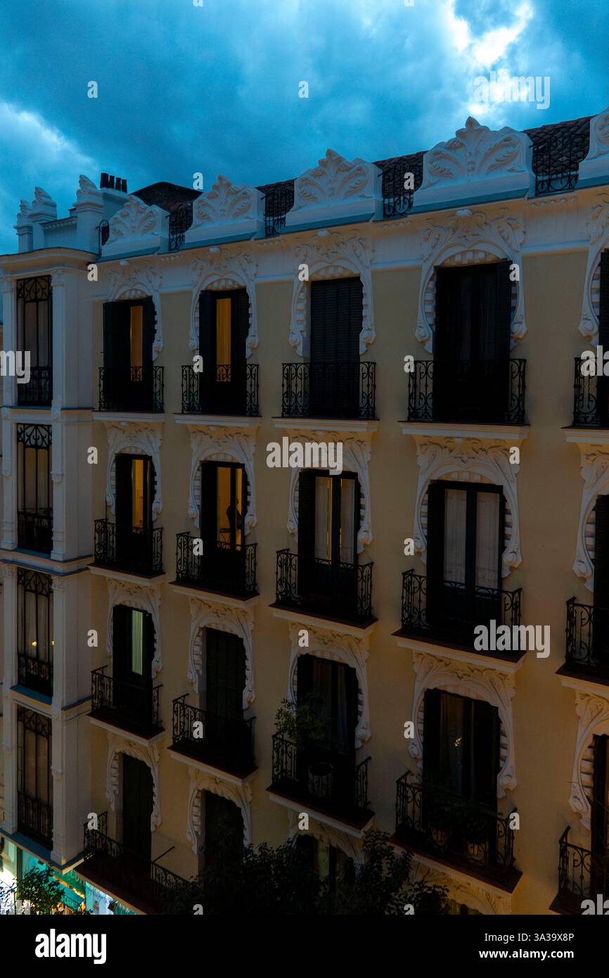 A tall building that features numerous windows and many balconies Stock Photo - Alamy