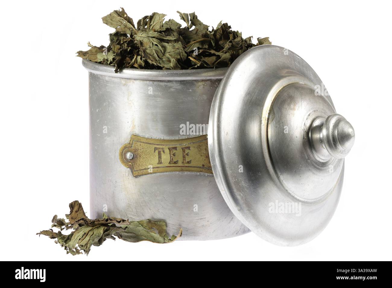 peppermint tea leaves in a vintage German aluminum lidded tin isolated ...