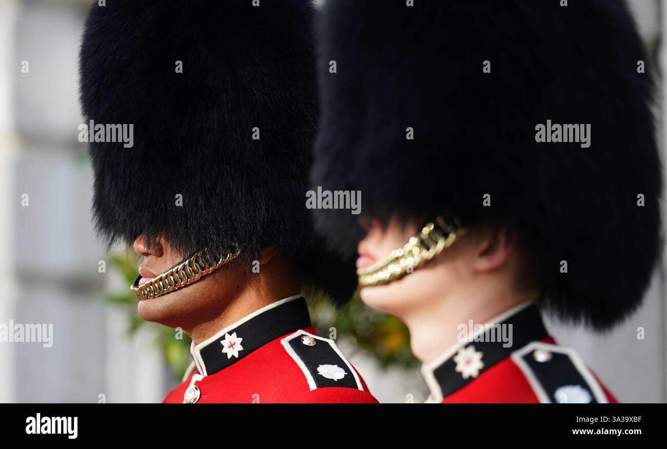 Members of the Coldstream Guards wait for Defence Secretary John Healey ...