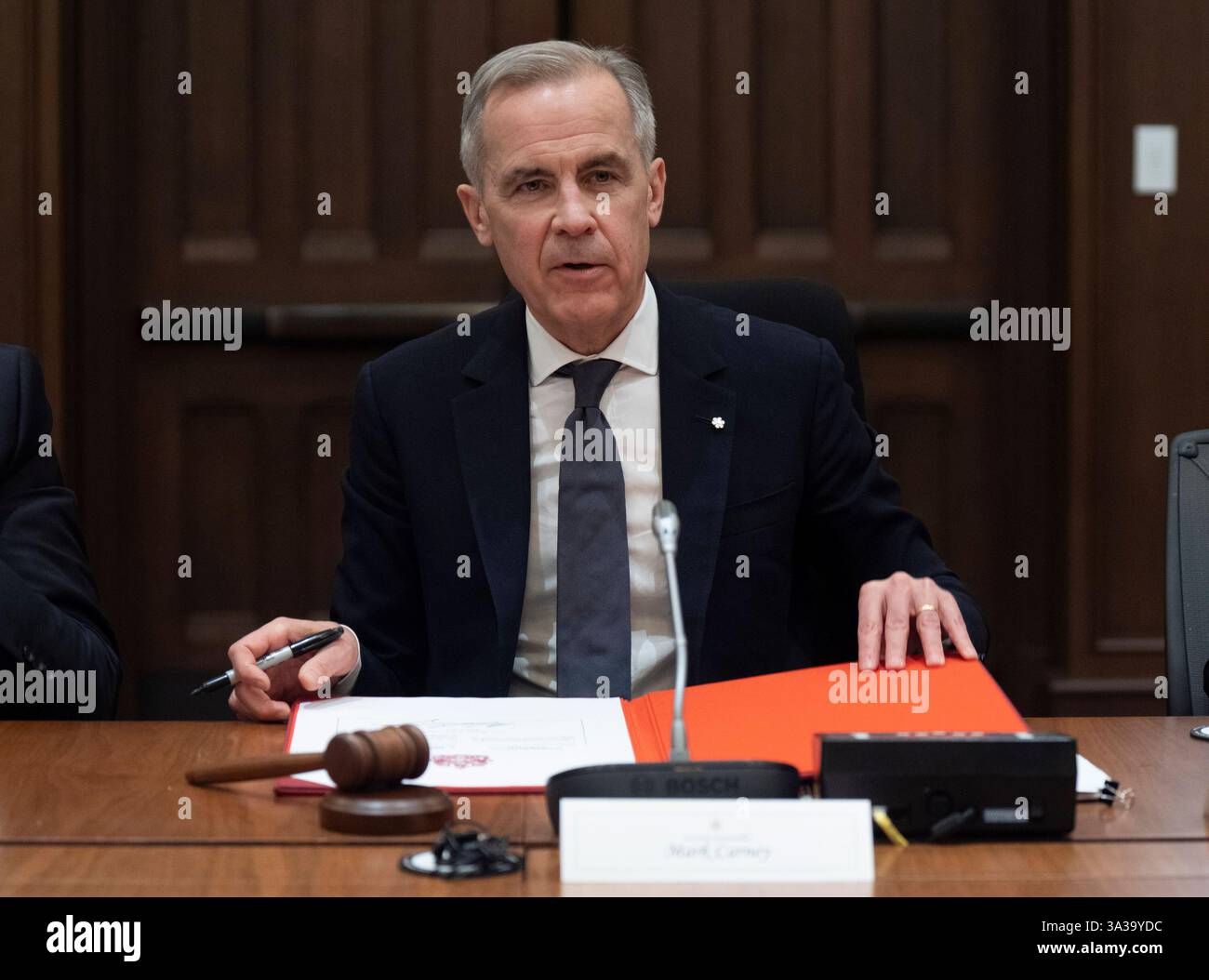 Prime Minister Mark Carney speaks after signing a document during ...
