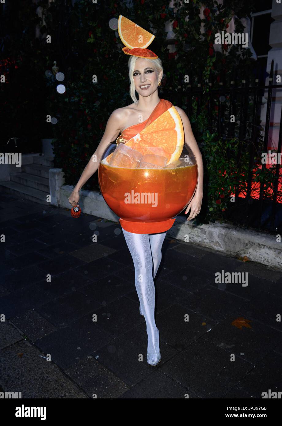 EDITORIAL USE ONLY Pixie Lott wears an Aperol Spritz Halloween costume ...