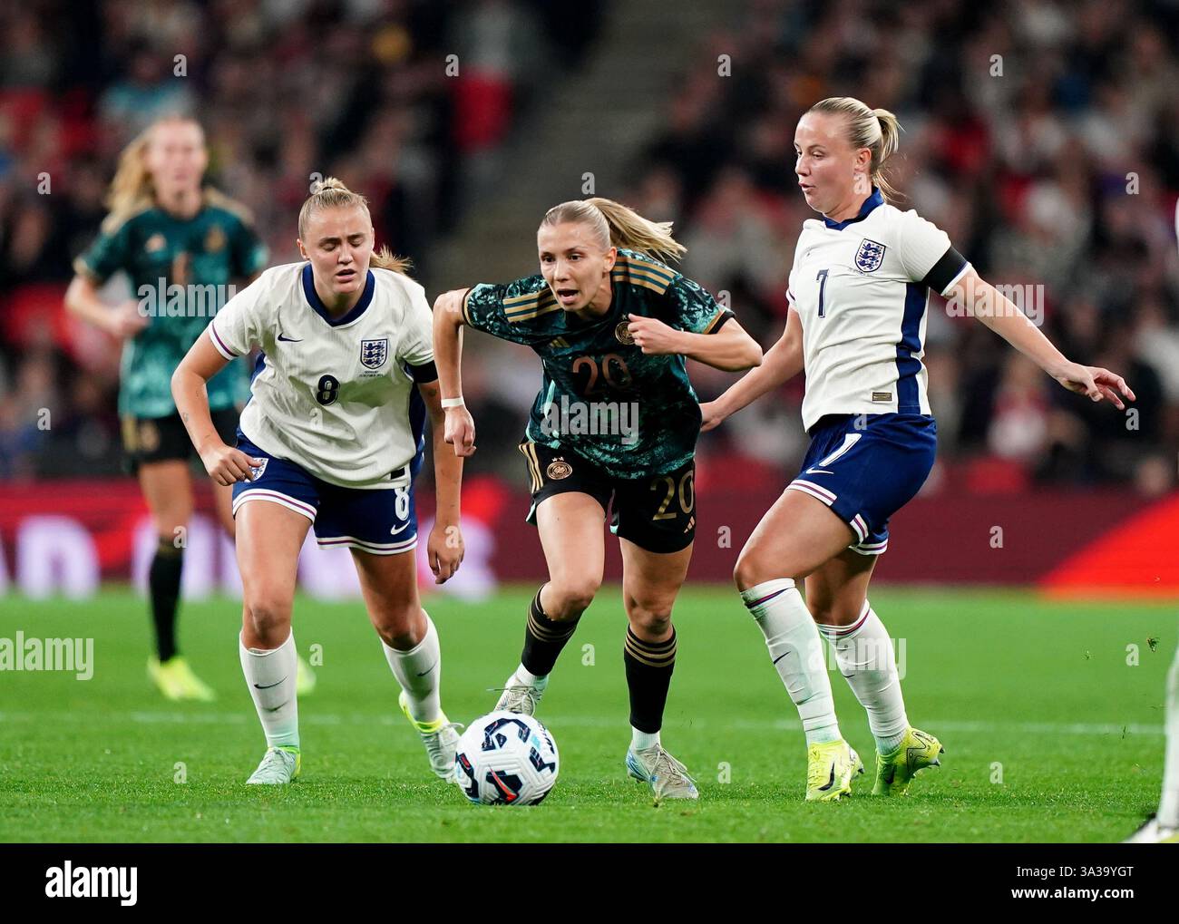 Germany's Elisa Senb (centre) battles for the ball with England's ...