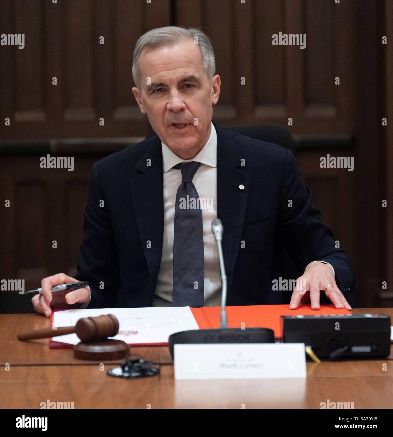 Prime Minister Mark Carney speaks after signing a document during ...