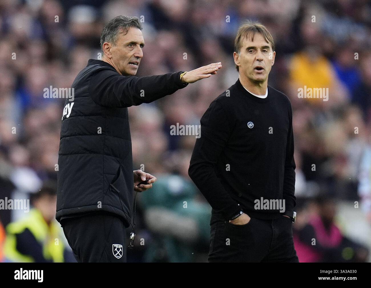 West Ham United assistant head coach Pablo Sanz (left) gestures on the ...