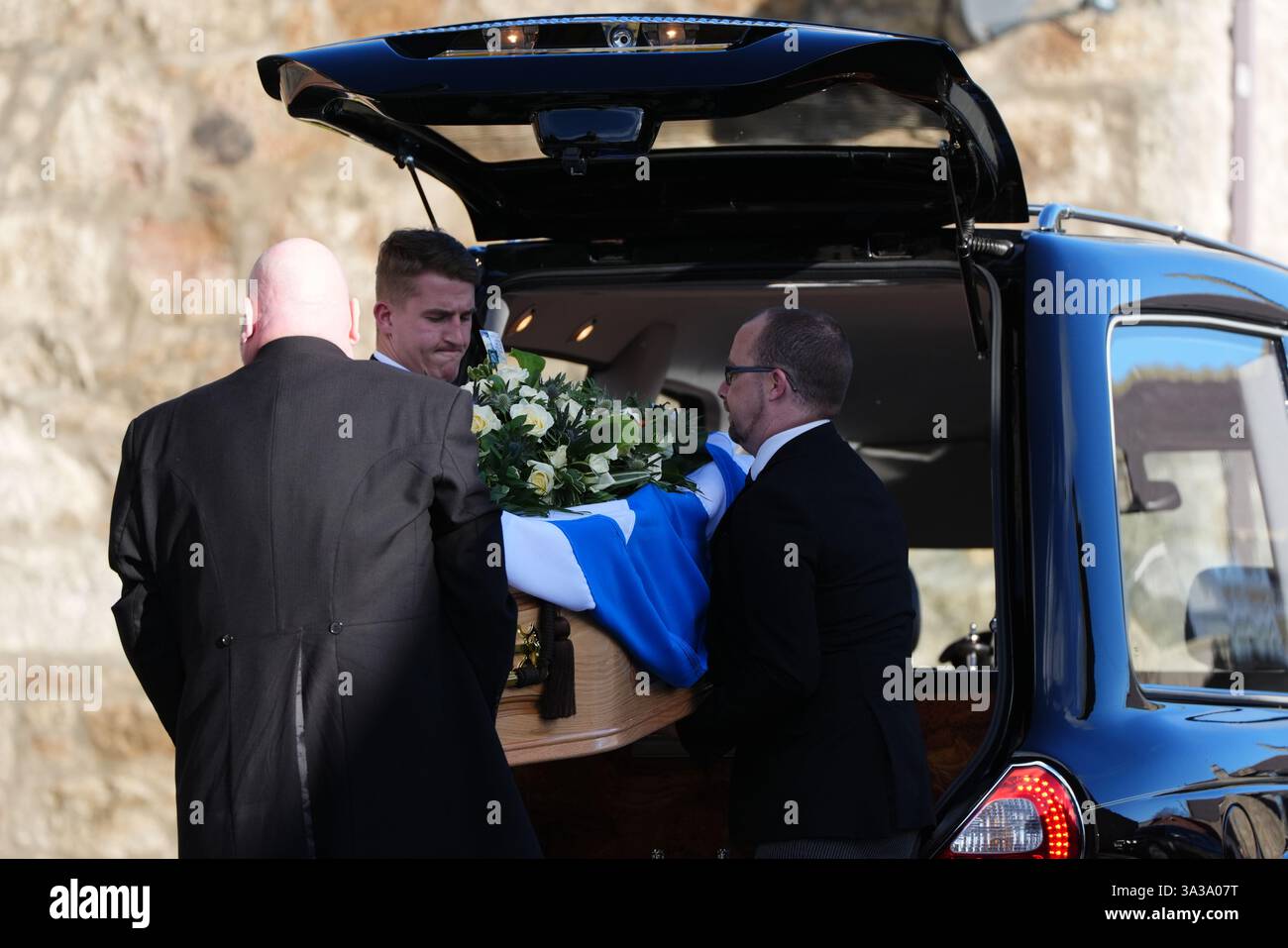 Pall bearers carry the coffin into the funeral service of the former ...