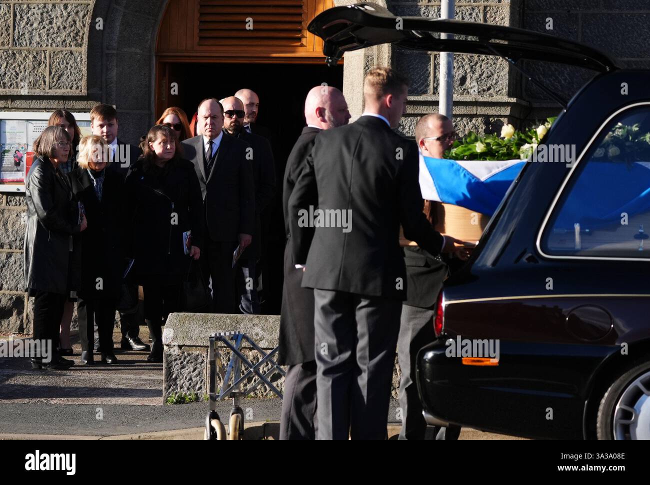 Moira Salmond (second left) leaves the funeral service for her husband ...