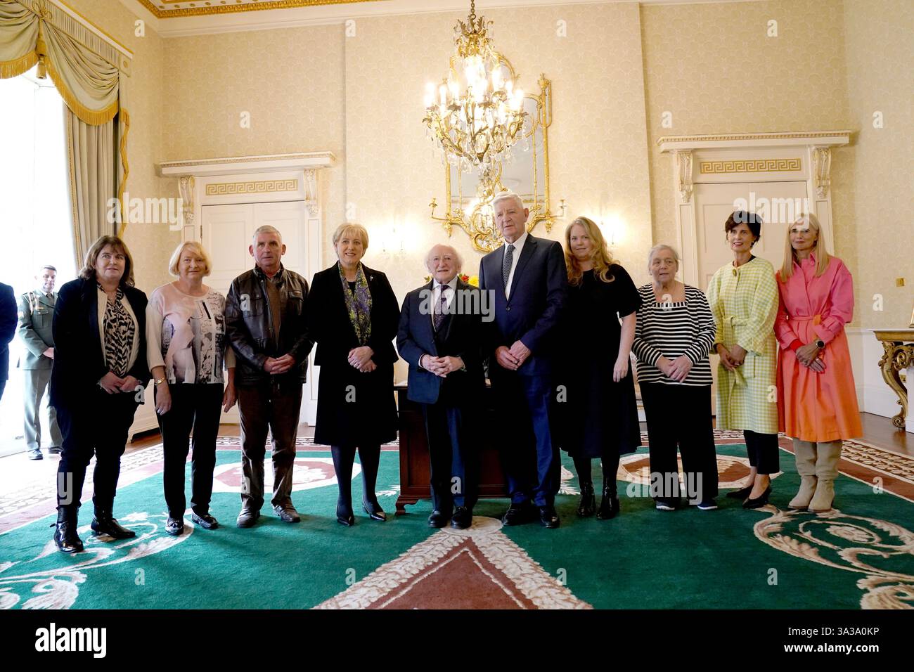 President Michael D Higgins stands with family relatives of Sylvester ...