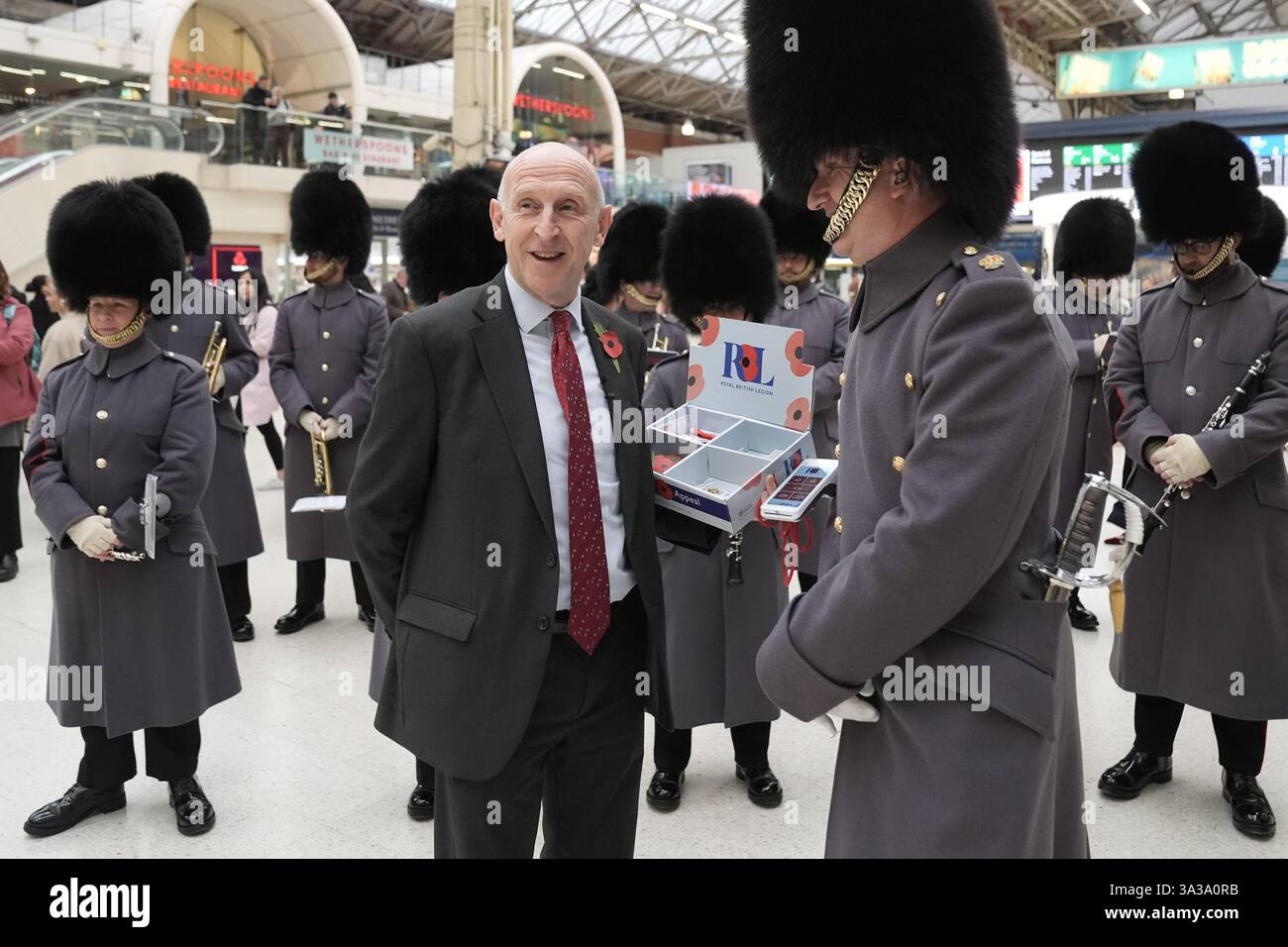 Defence Secretary John Healey joins serving military personnel to hand ...