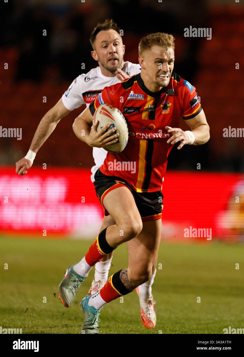 Salford Red Devils' Ryan Brierley trips Bradford Bulls' Luke Hooley ...
