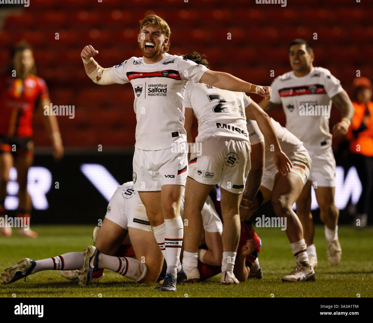 Salford Red Devils' Kai Morgan reacts to a try-saving tackle during the ...