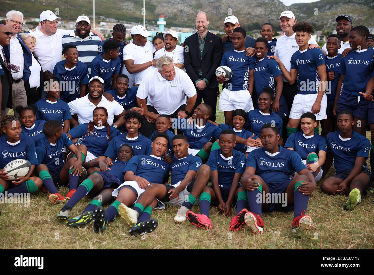 The Prince of Wales poses for a photo with local school children and ...