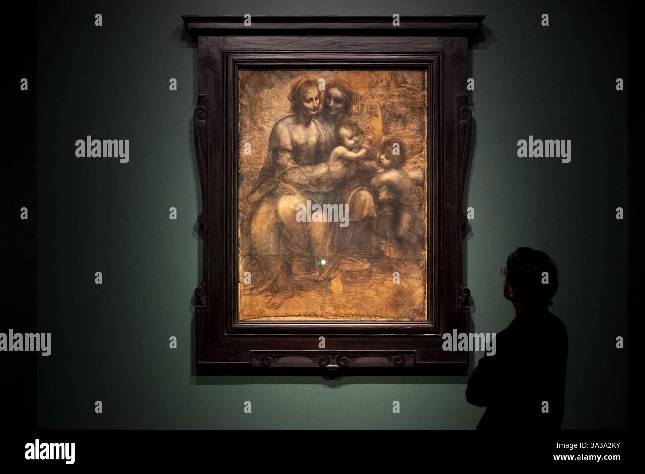 A gallery assistant with The Virgin and Child with Saint Anne and the ...