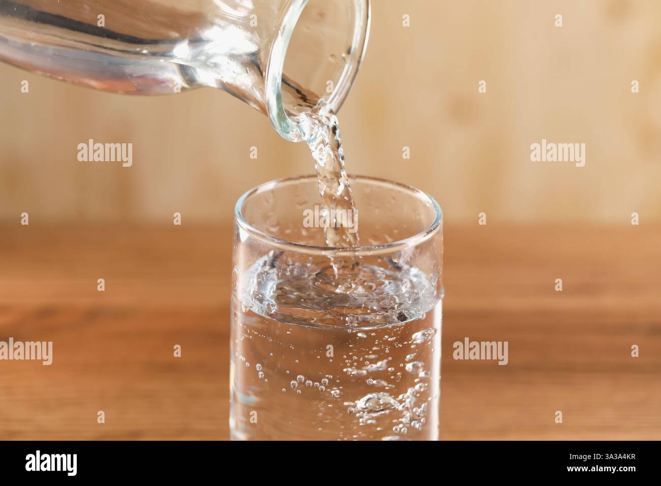 Pouring refreshing soda water into glass against blurred background, closeup Stock Photo - Alamy