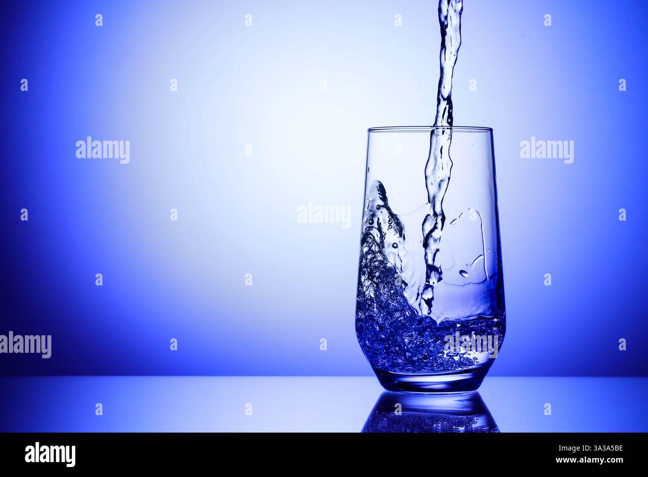 Pouring refreshing soda water into glass on blue background, closeup. Space for text Stock Photo ...
