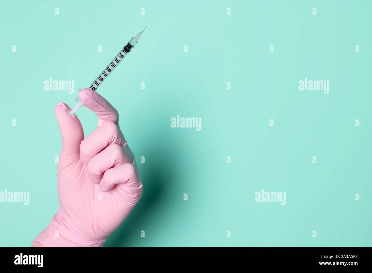 Doctor holding syringe with medication on turquoise background, closeup ...