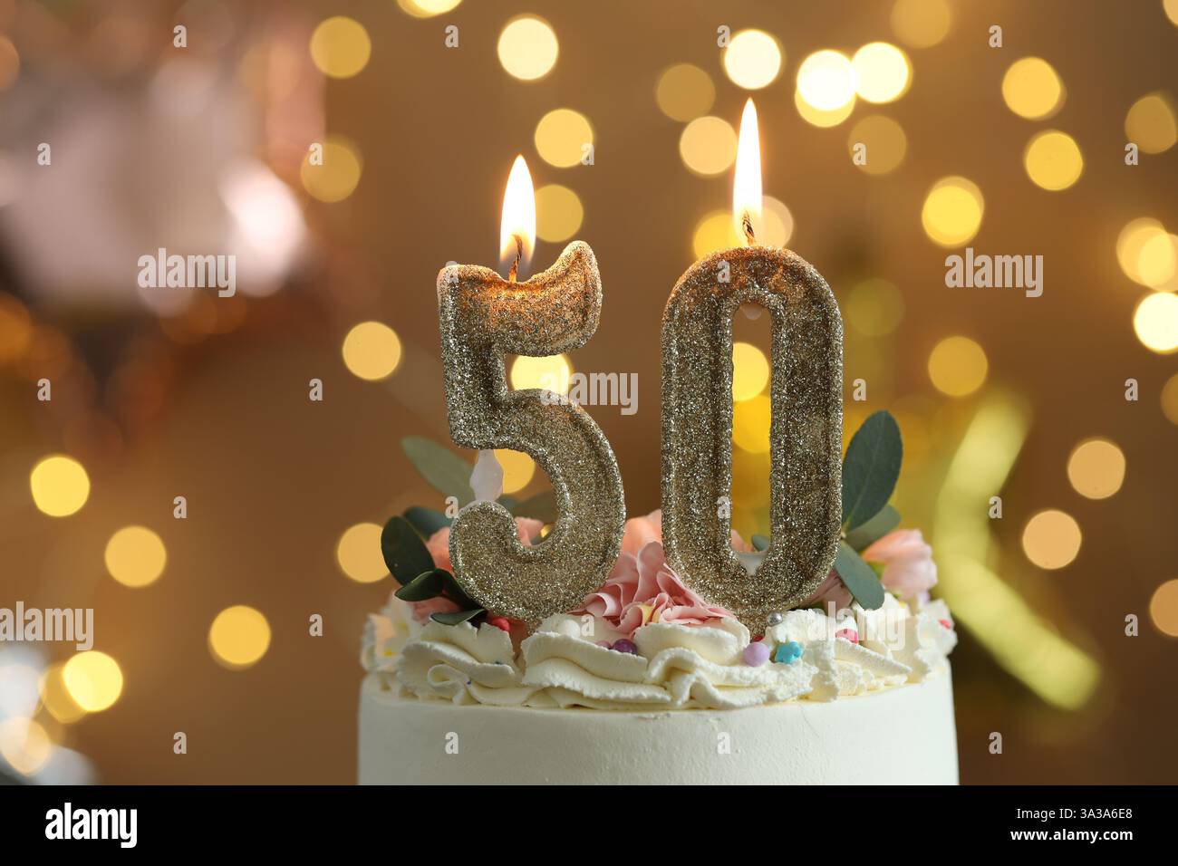 50th birthday. Tasty cake with burning number shaped candles and ...