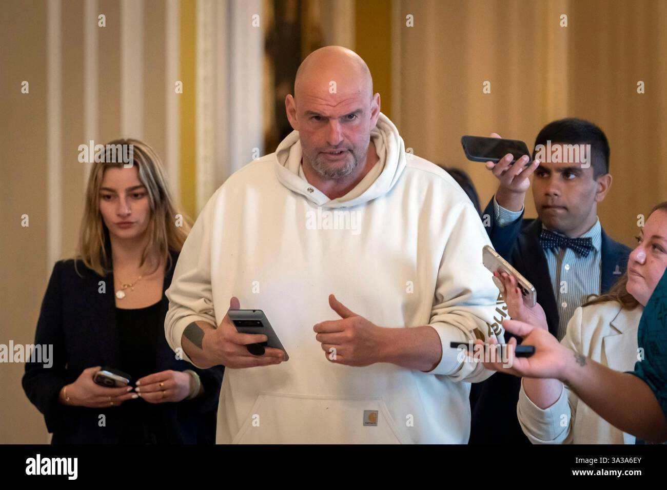 Sen. John Fetterman, D-Pa., speaks to reporters as he walks near the ...