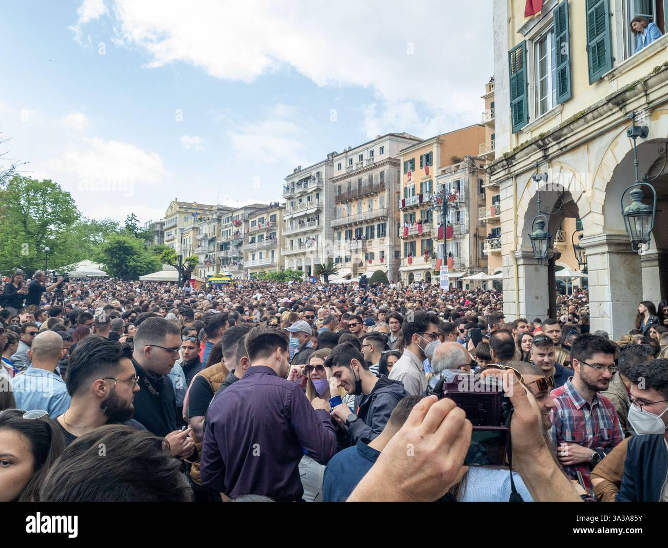 Large crowd gathers in a European city square, with people watching ...