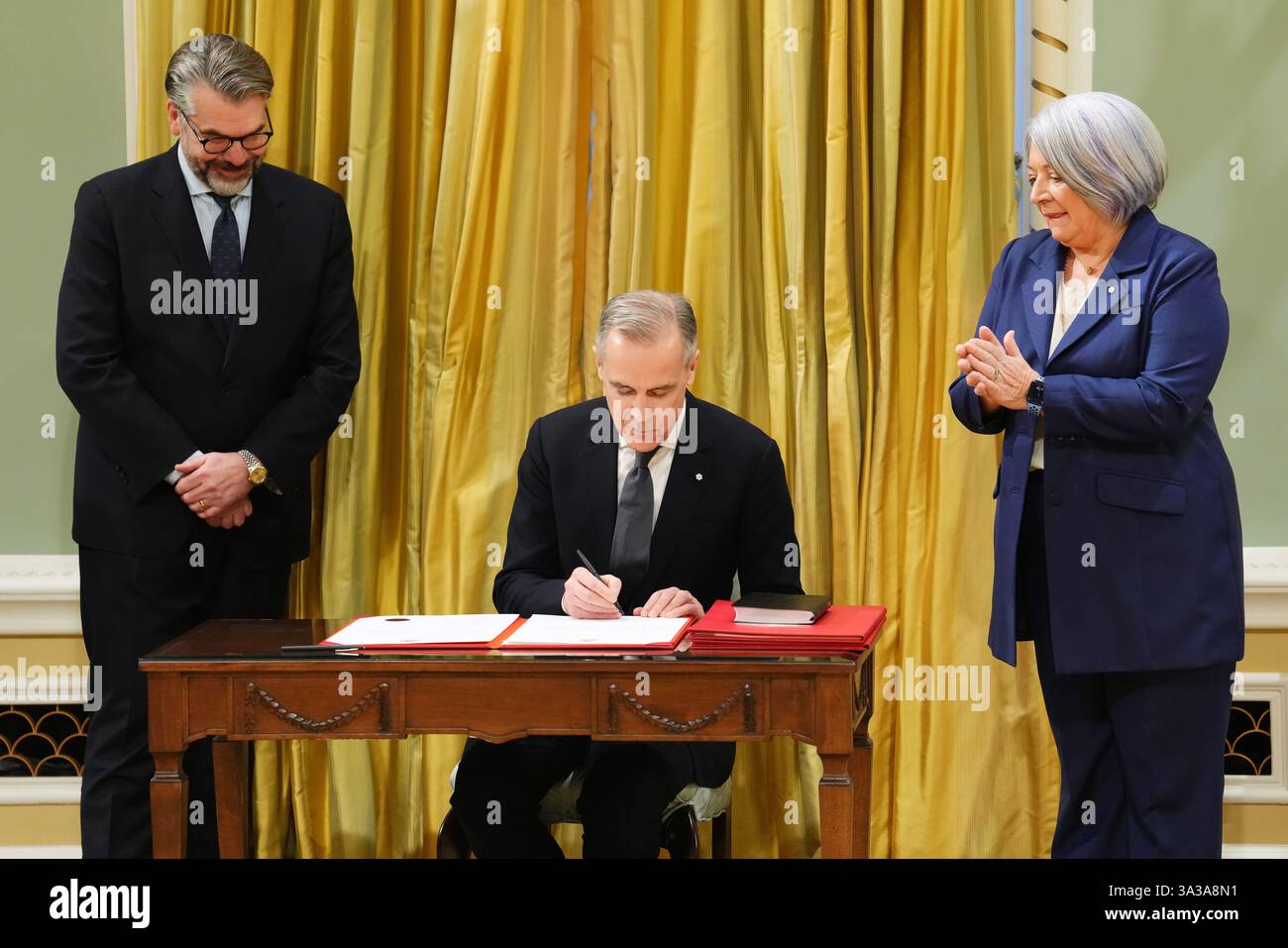 Ottawa, Canada. 14th Mar, 2025. Prime Minister Mark Carney signs after ...