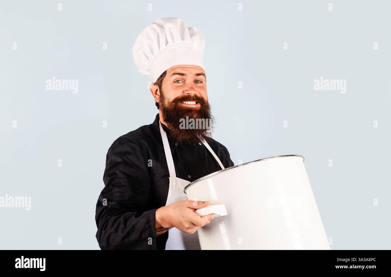Smiling chef man with big pot at restaurant kitchen. Cooking and ...