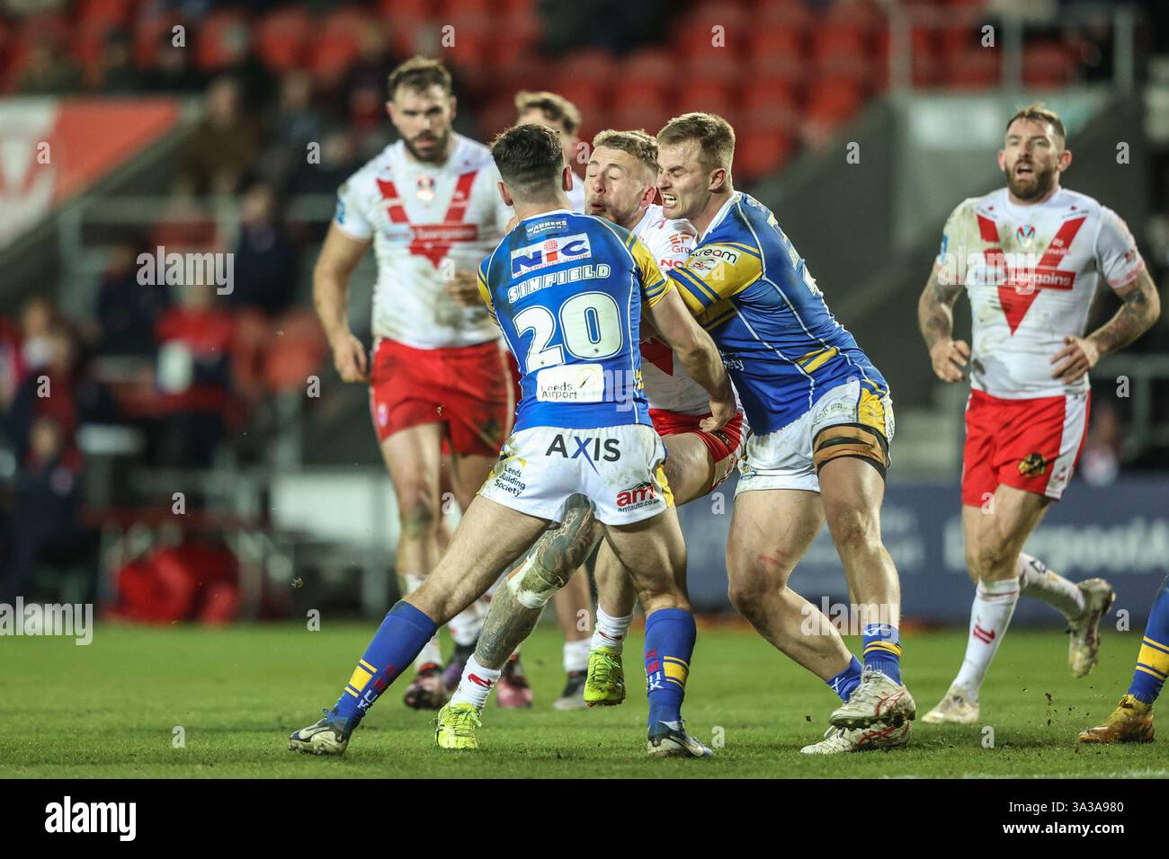 St Helens, UK. 14th Mar, 2025. Jake Wingfield of St. Helens is tackled ...