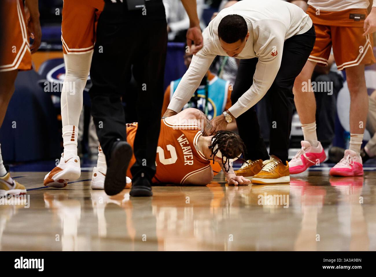 Texas guard Chendall Weaver (2) lies injured against the Tennessee ...
