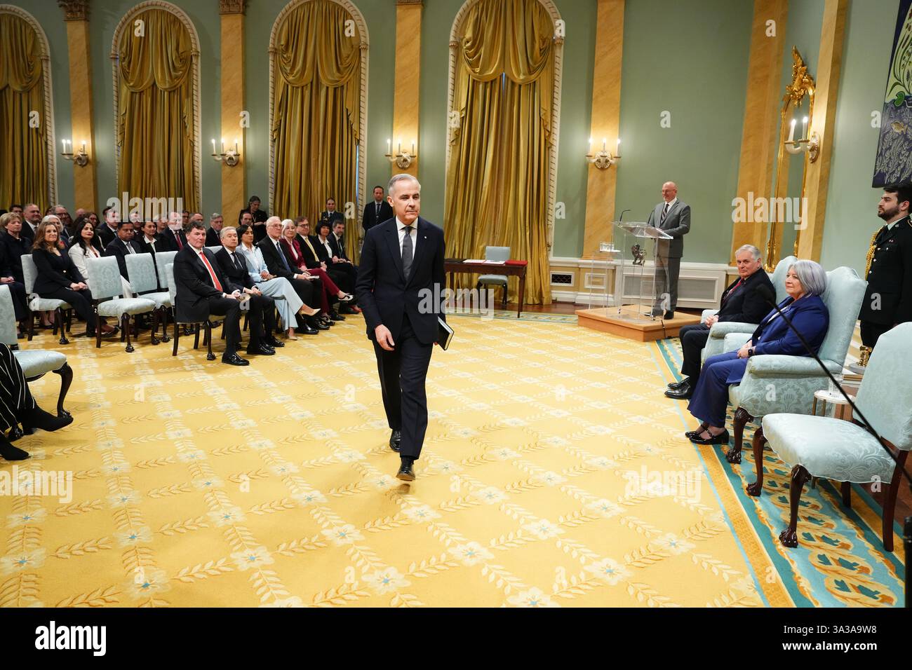 Mark Carney comes forward to be sworn in as prime minister during a ...