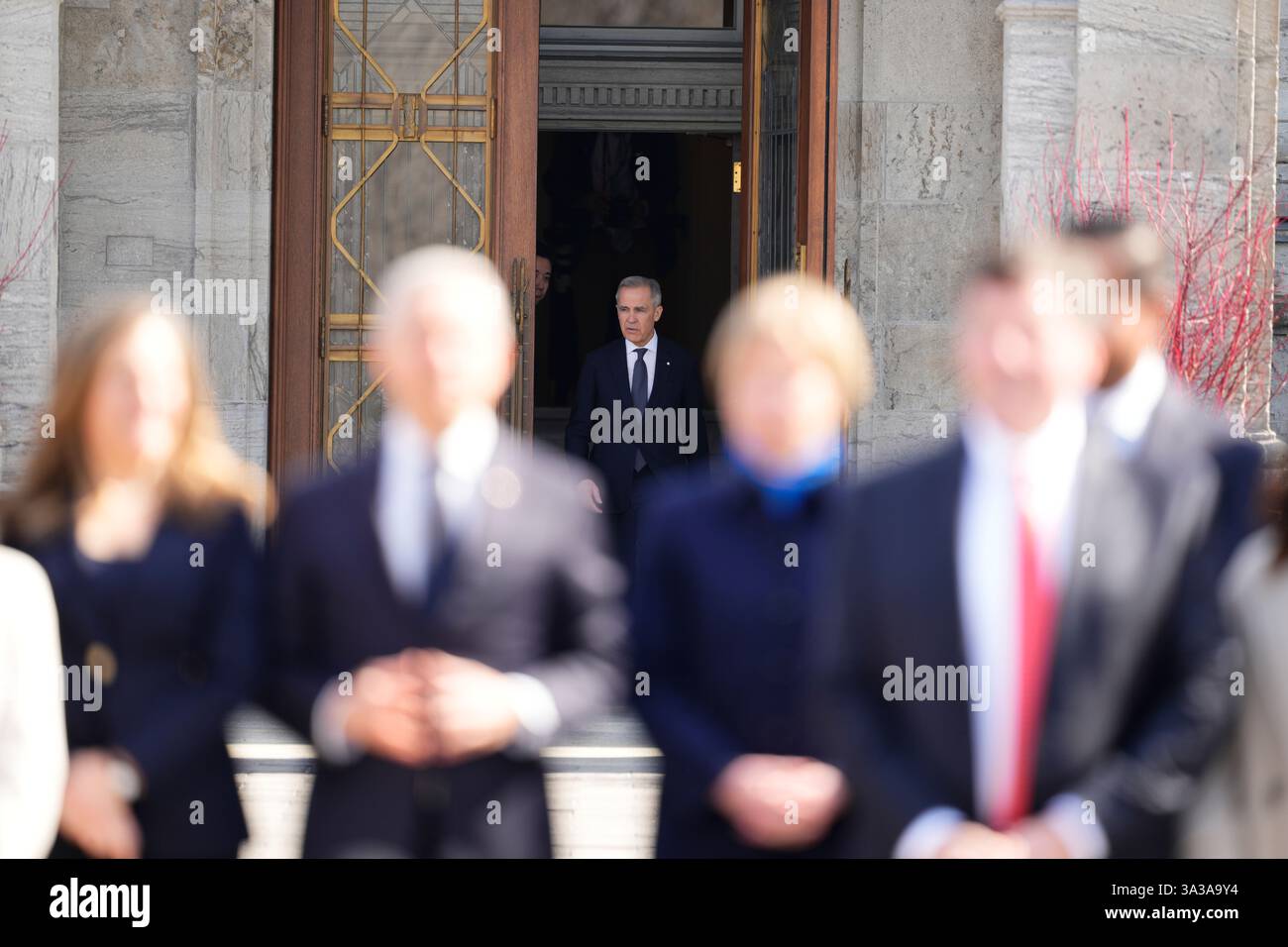 Members of the Liberal cabinet line up as Prime Minister Mark Carney ...