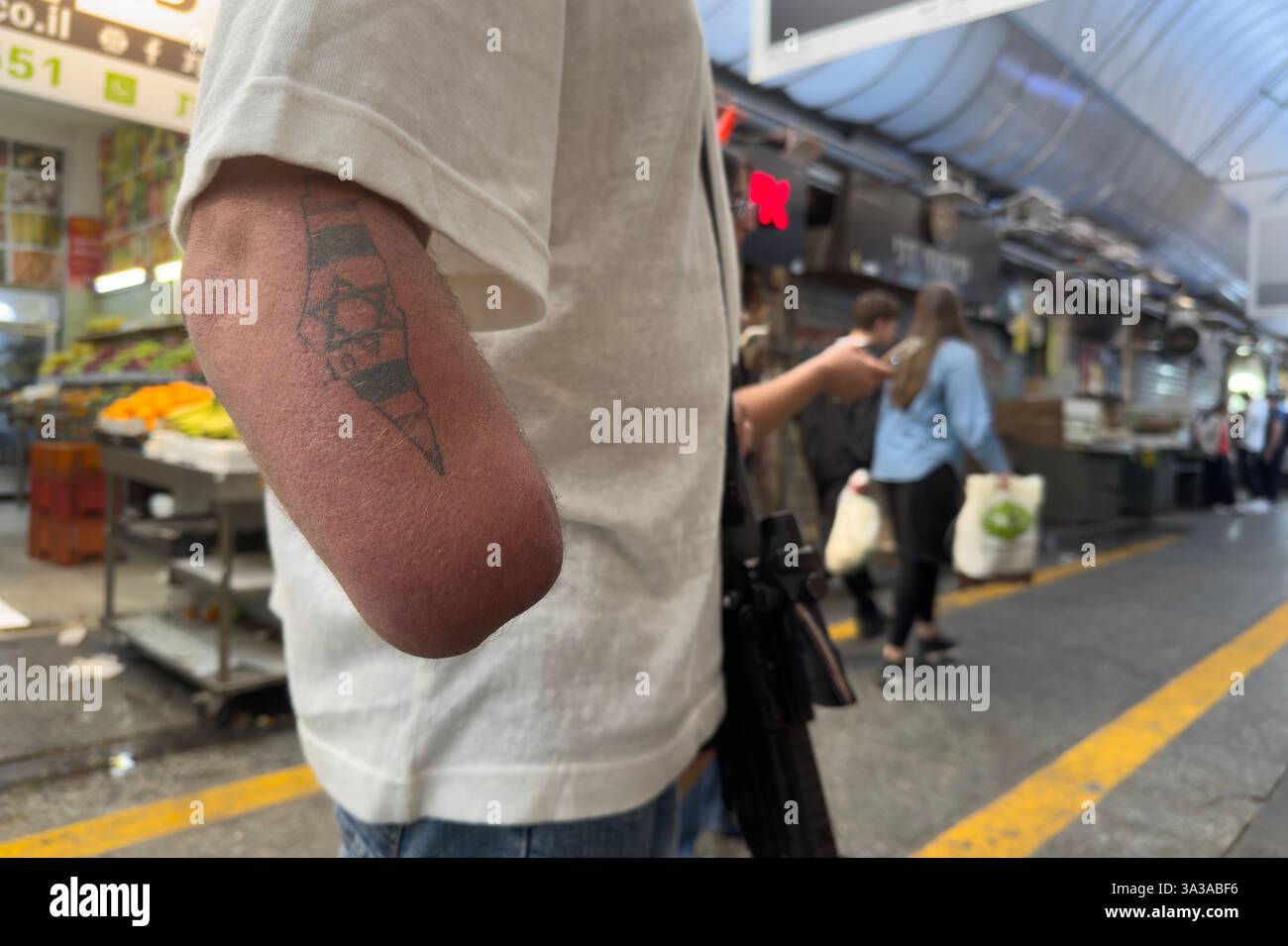 Off-duty Israeli soldier armed with an automatic assault rifle with ...