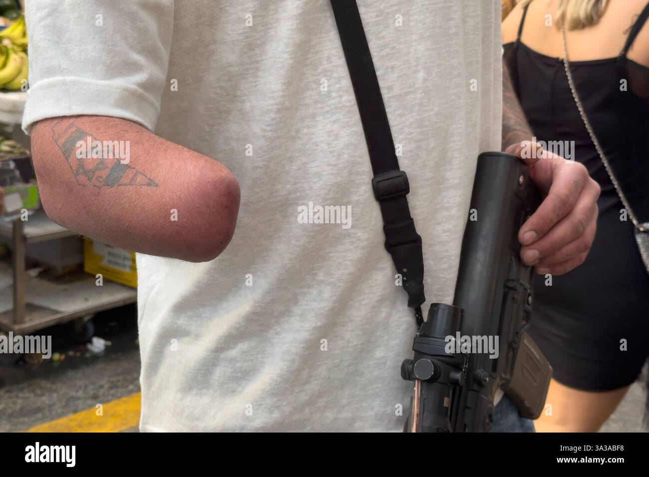 Off-duty Israeli soldier armed with an automatic assault rifle with ...