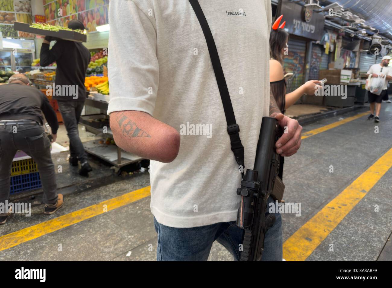 Off-duty Israeli soldier armed with an automatic assault rifle with ...