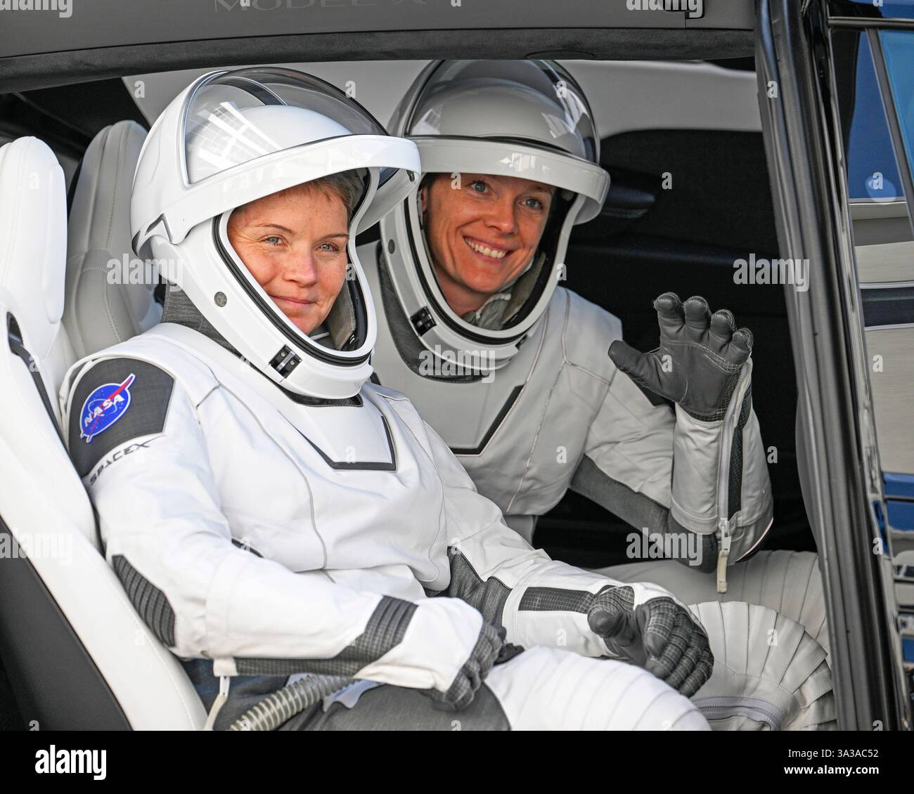 SpaceX NASA Crew-10 members and NASA Astronauts Nichole Ayers (r) and Anne McClain peer out of a ...
