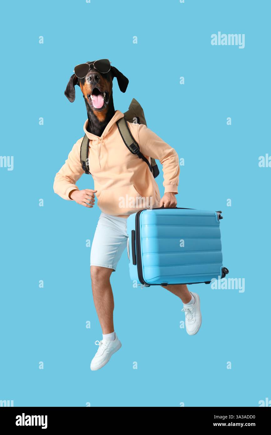 Running male tourist with head of dog on light blue background Stock ...