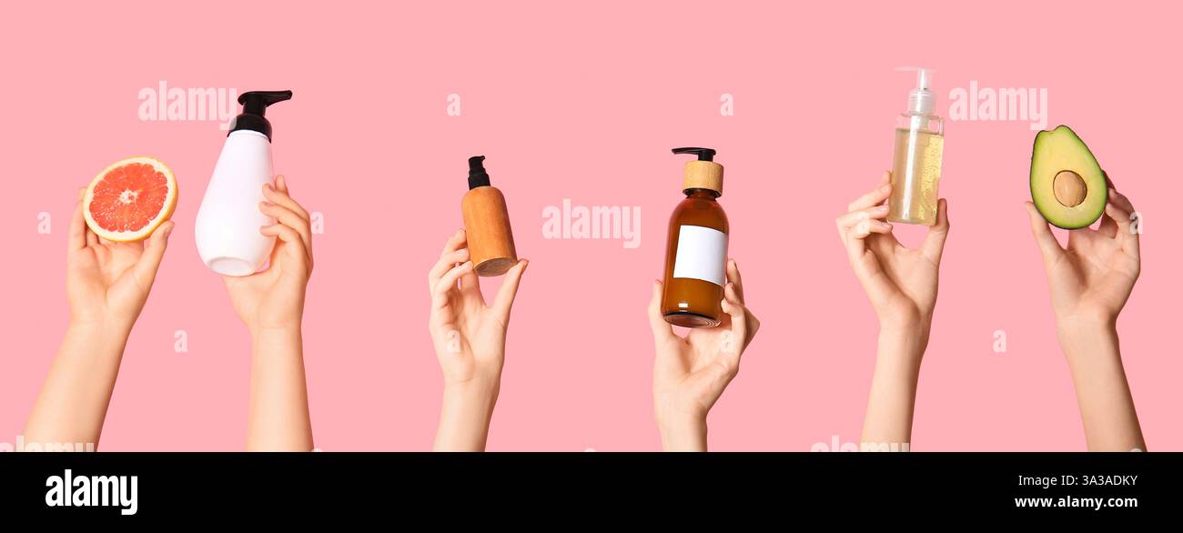 Female hands with different cosmetic products and fruits on pink ...