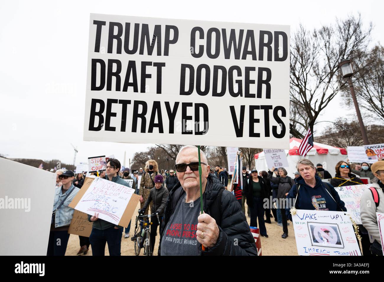 Washington, United States. 14th Mar, 2025. Man with a sign saying ...