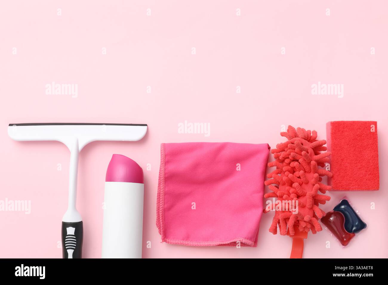 Set of cleaning supplies on pink background Stock Photo - Alamy