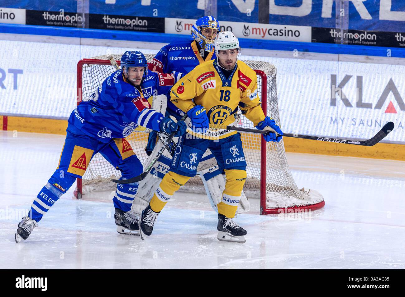 Niklas Hansson #19 (EV Zug) pushes Filip Zadina #18 (HC Davos) aside ...