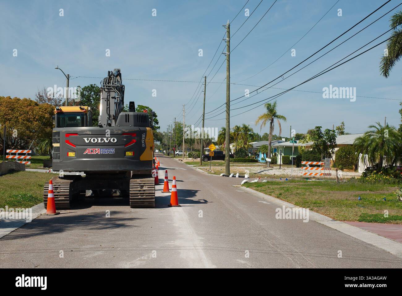 Excavator backhoe along with other construction vehicles, traffic cones ...