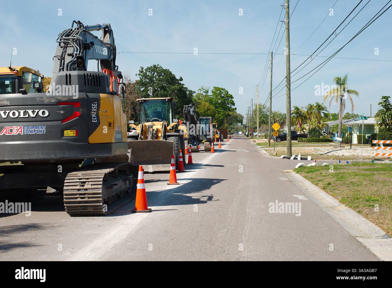 Excavator backhoe along with other construction vehicles, traffic cones ...