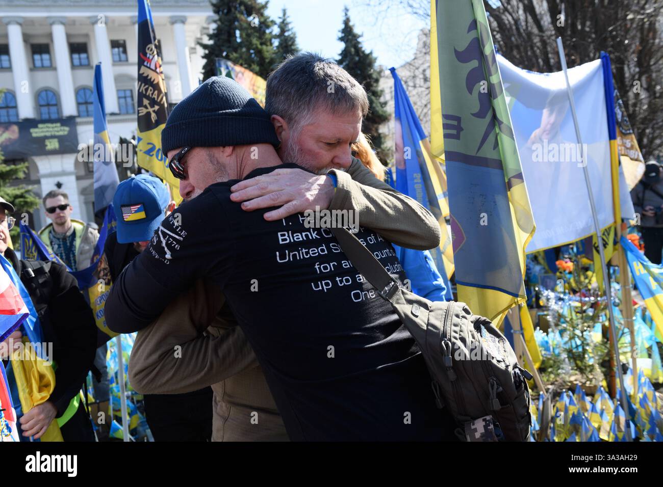 Participants hug each other during the ceremony to honour the memory of ...